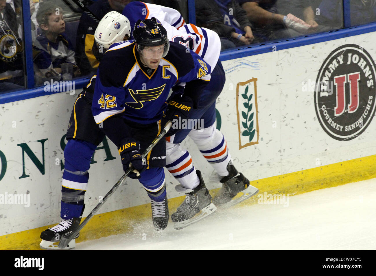 St. Louis Blues David Backes (42) checks Edmonton Oilers Mark Fraser (5 ...