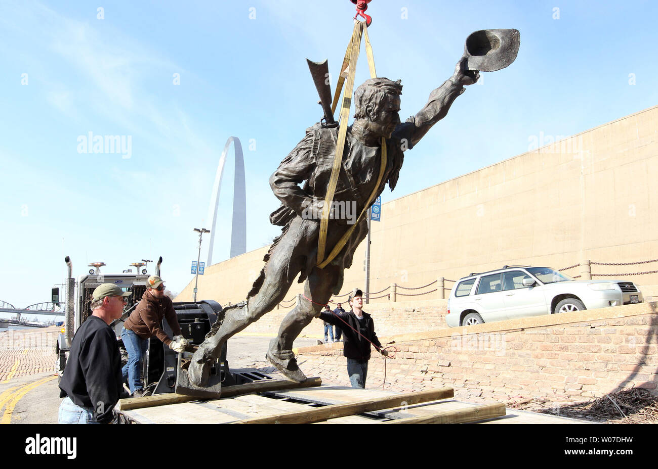 Section one of "The Captains Return" statue is lowered by crane onto a ...