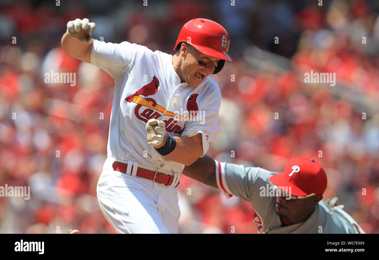 St. Louis Cardinals Mark Ellis is tagged out at first base after laying ...