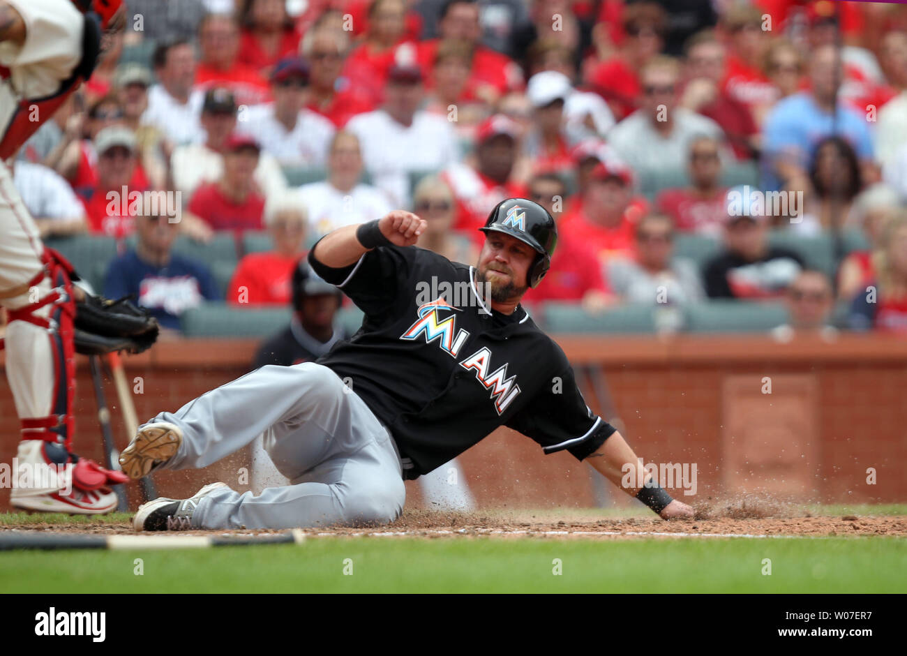 Miami Marlins Casey McGehee slides safely with the go-ahead run before ...
