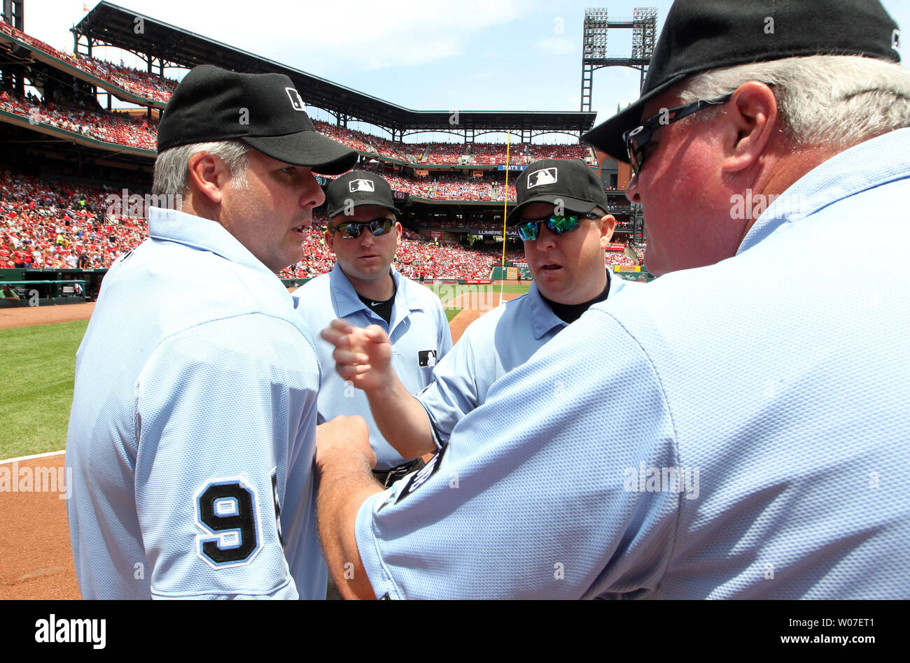 Home plate umpire Tim Timmons gets a tap to the chest protector by crew ...