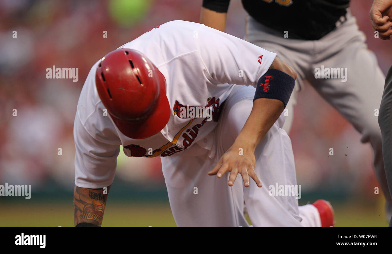 St. Louis Cardinals Yadier Molina looks for feeling in his left hand ...