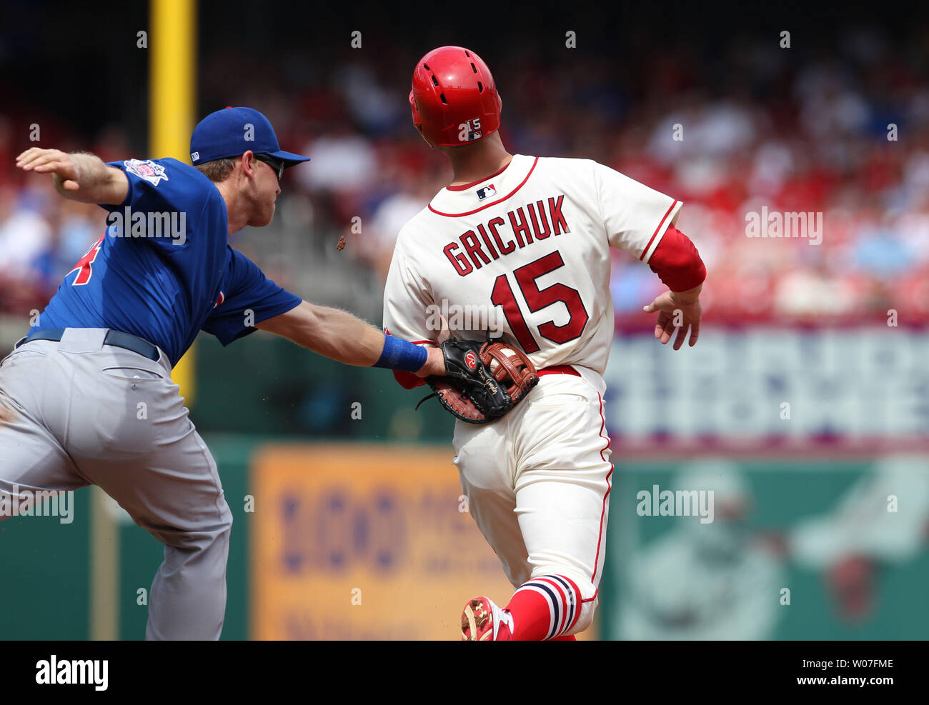 Chicago Cubs Chris Valaika reaches to tag out St. Louis Cardinals ...