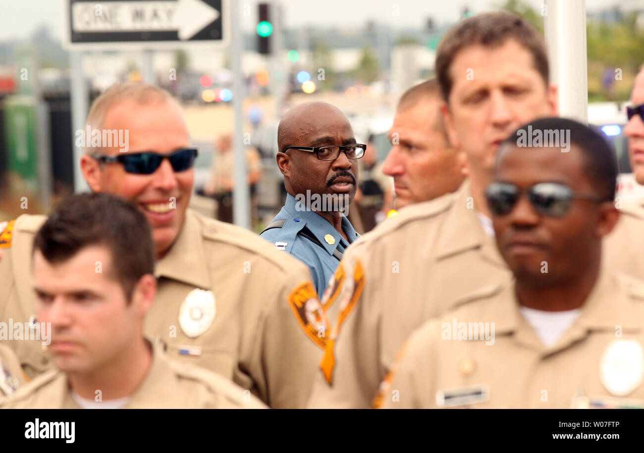 Captain Ron Johnson (C) of the Missouri State Highway Patrol, stands ...