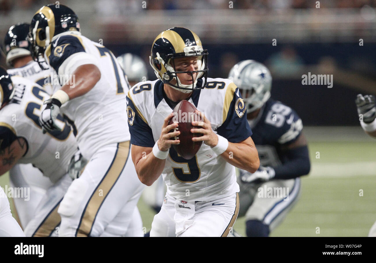 St. Louis Rams quarterback Austin Davis rolls out to pass the football ...