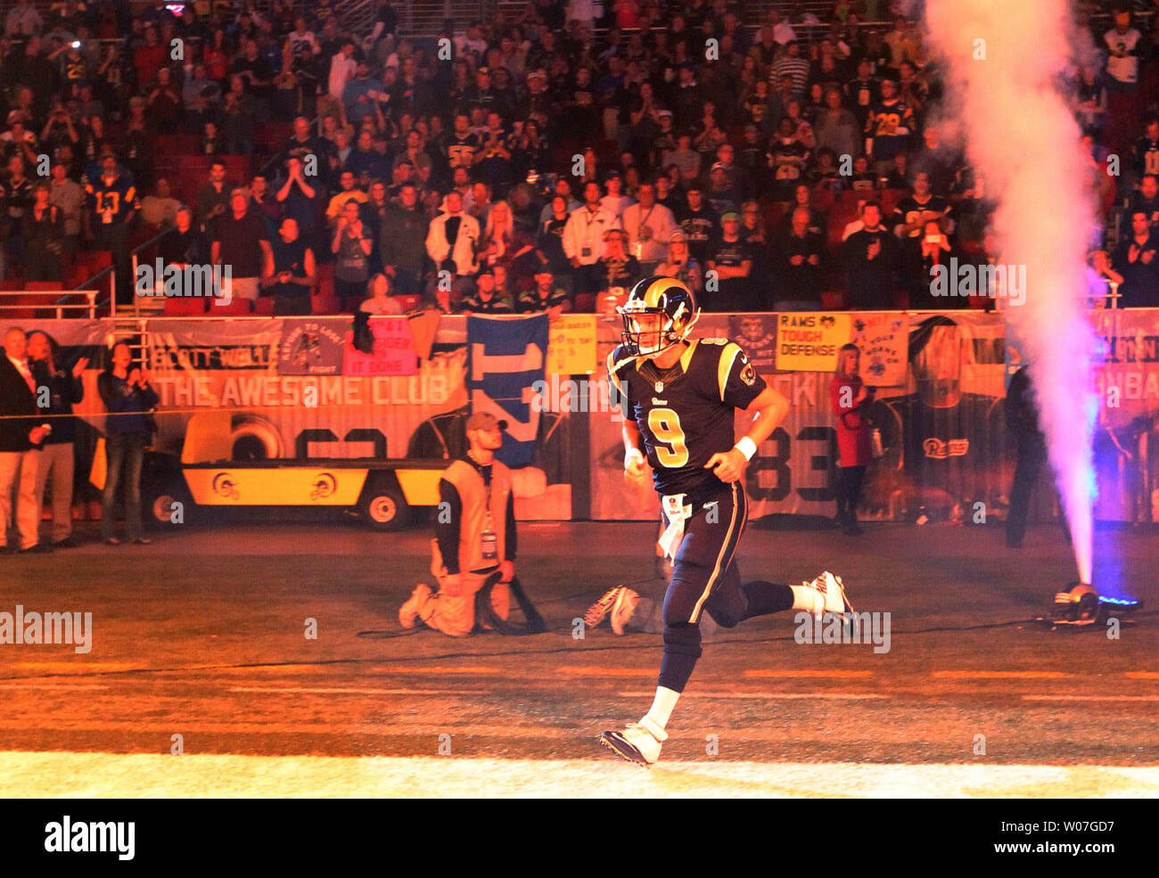 St. Louis Rams quarterback Austin Davis runs onto the field as he is ...