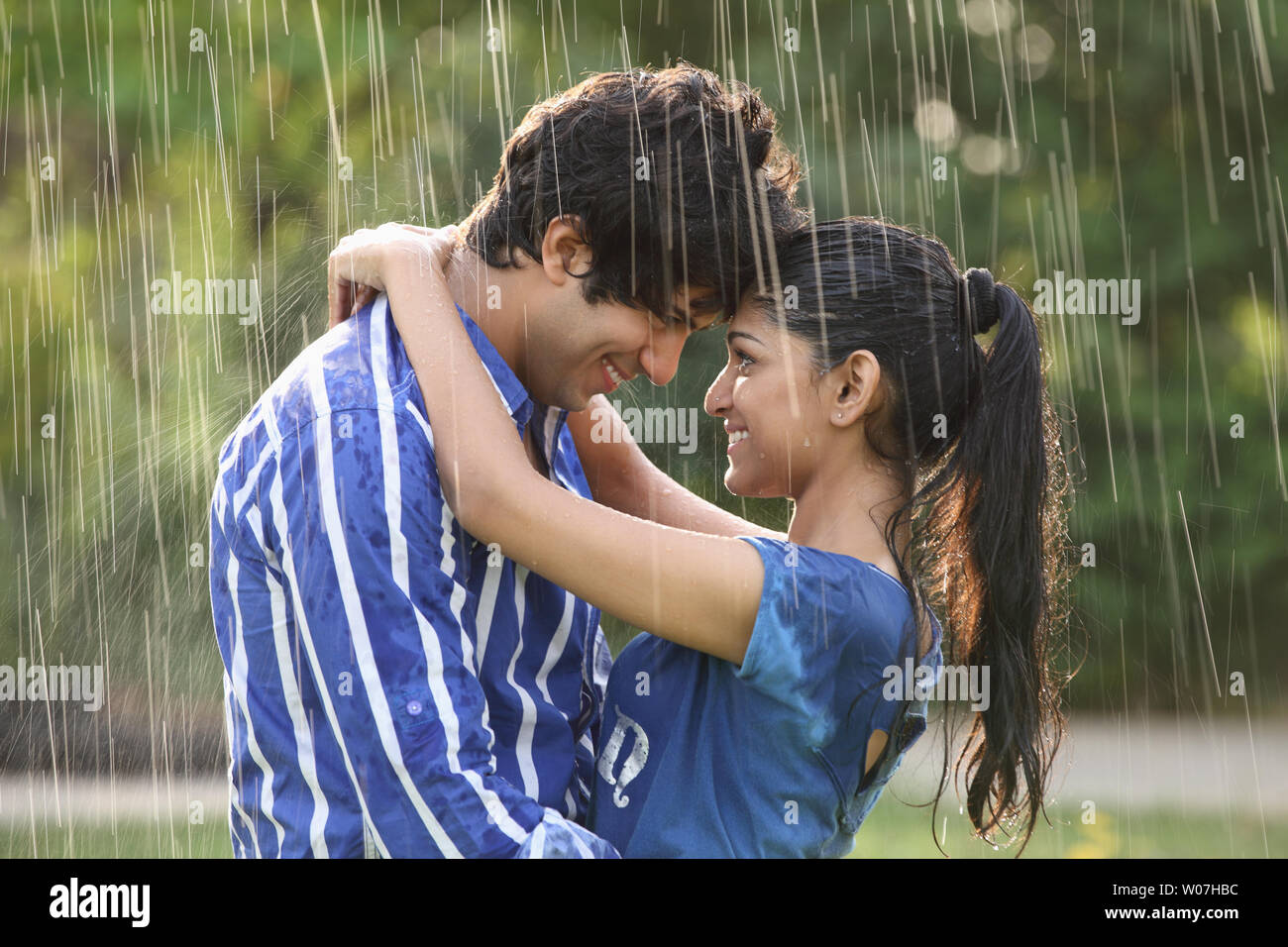 Indian young couple romancing in the rain Stock Photo - Alamy