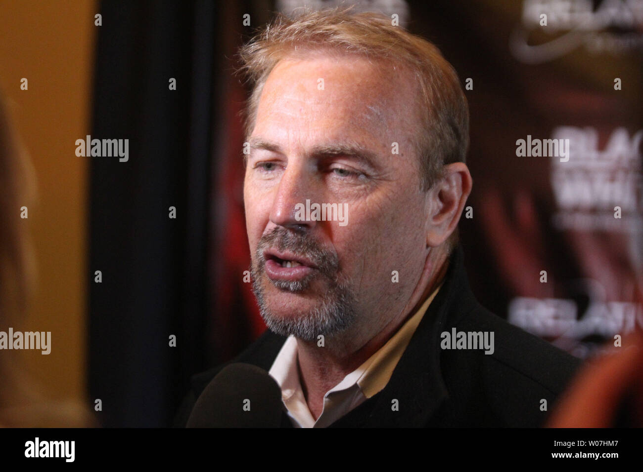 Actor Kevin Costner talks with reporters as he arrives at the ...