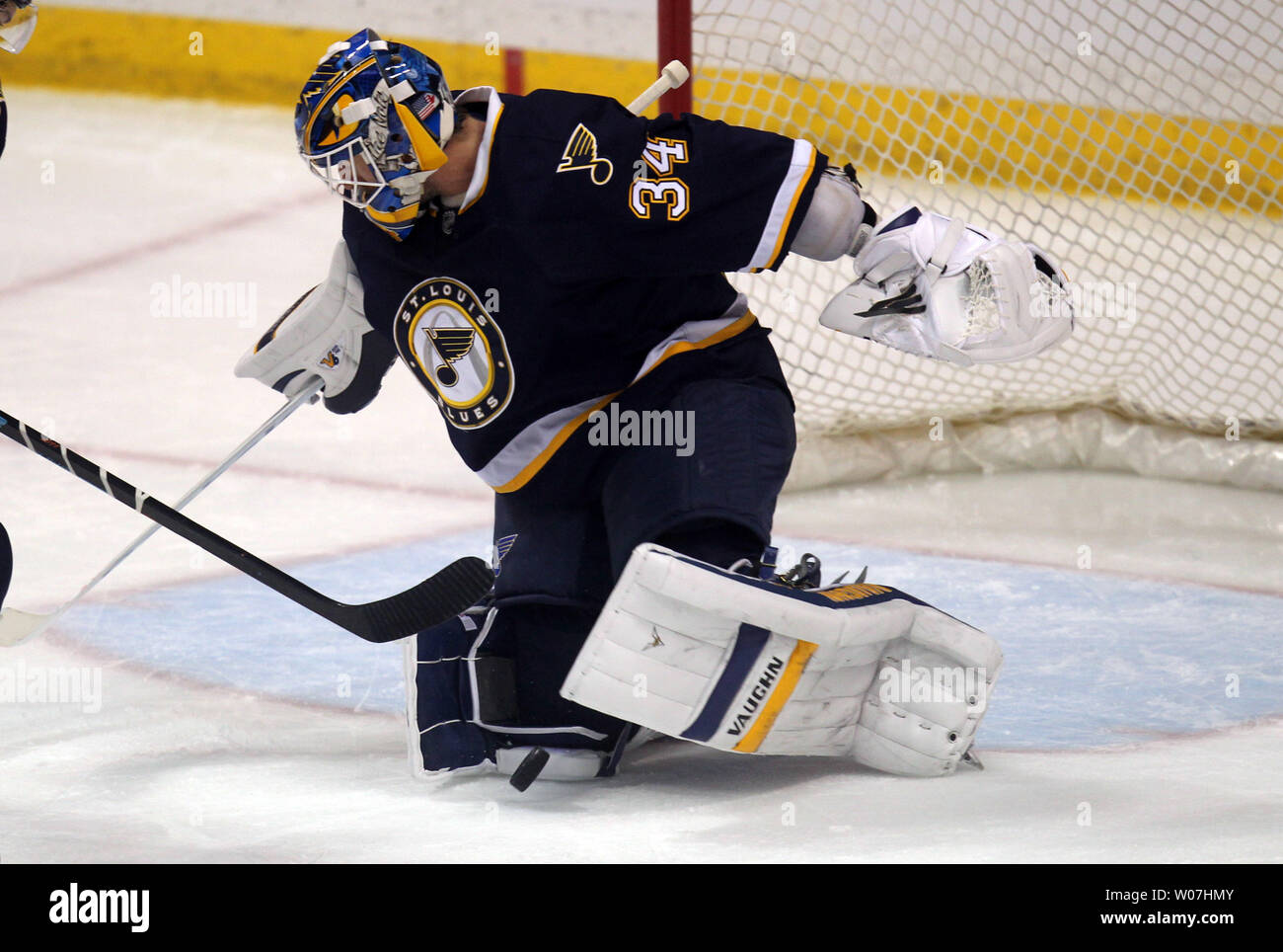 St. Louis Blues goaltender Jake Allen uses his knee to stop the puck ...