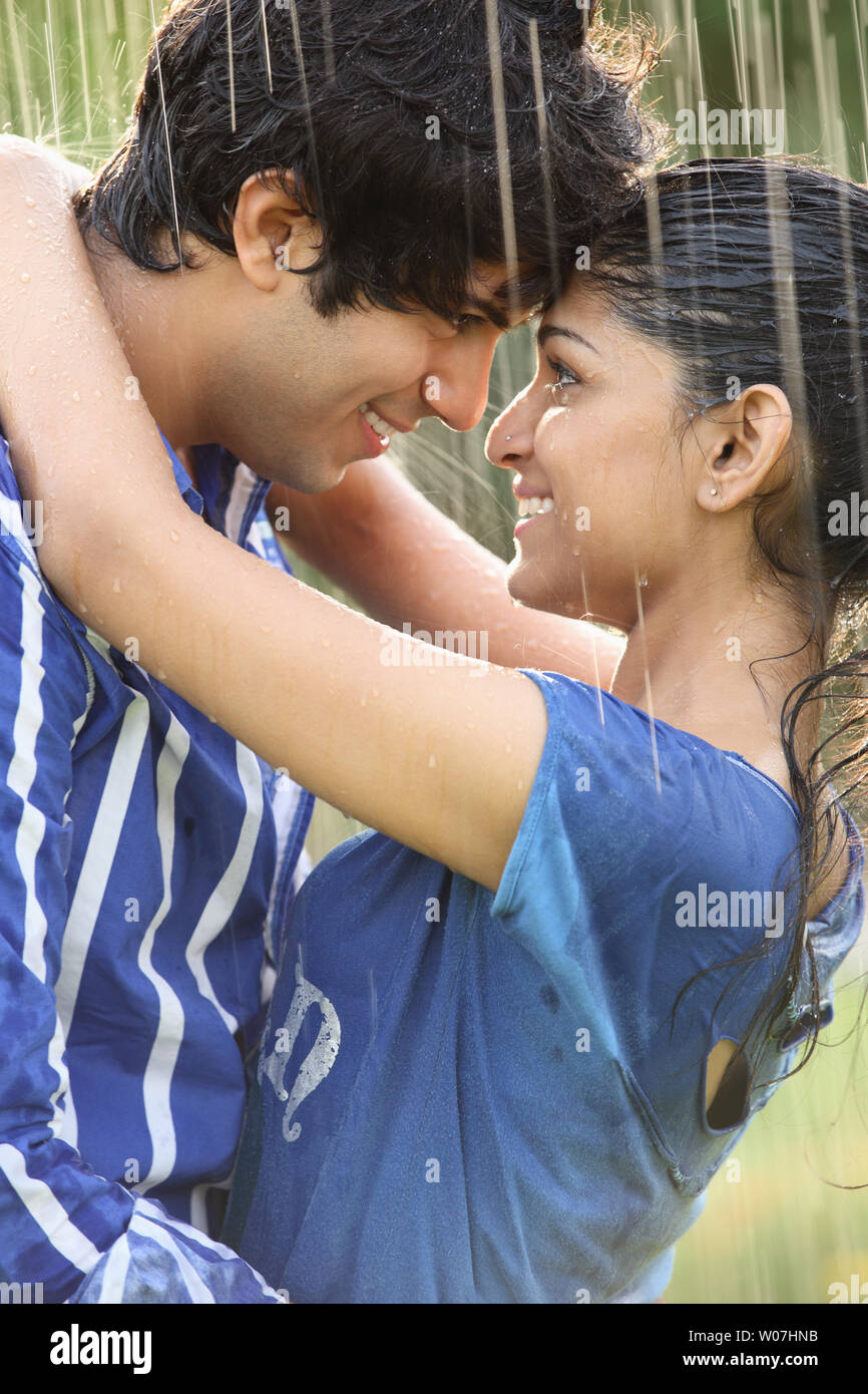 Indian young couple romancing in the rain Stock Photo - Alamy