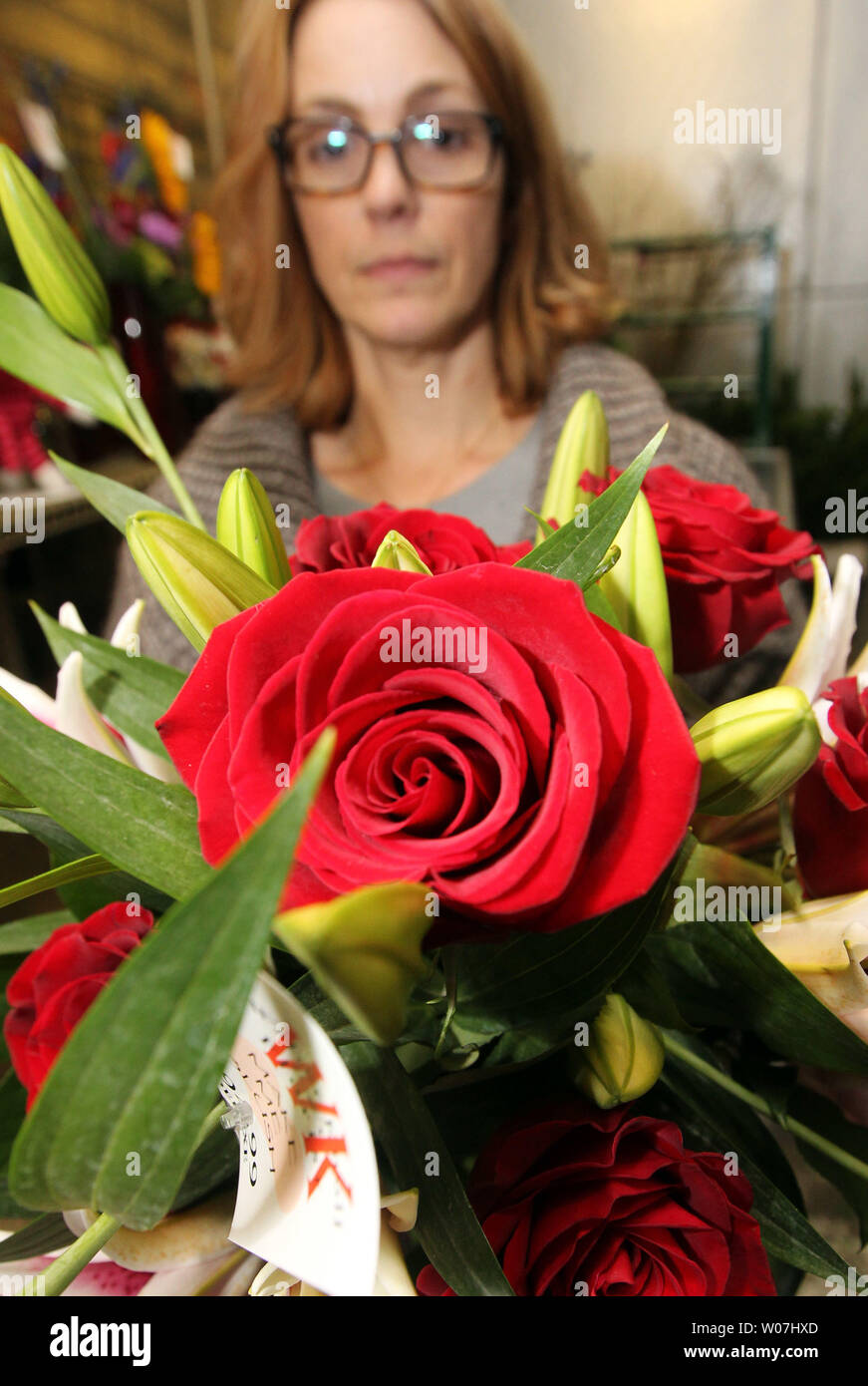 Flower designer Tina Sanders shows off a popular red Ecuador rose at ...