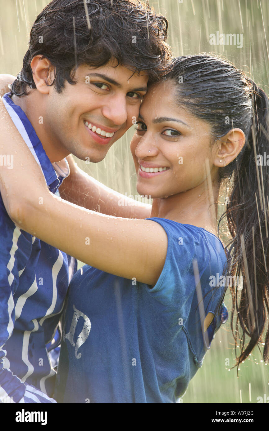 Couple romancing in the rain Stock Photo - Alamy