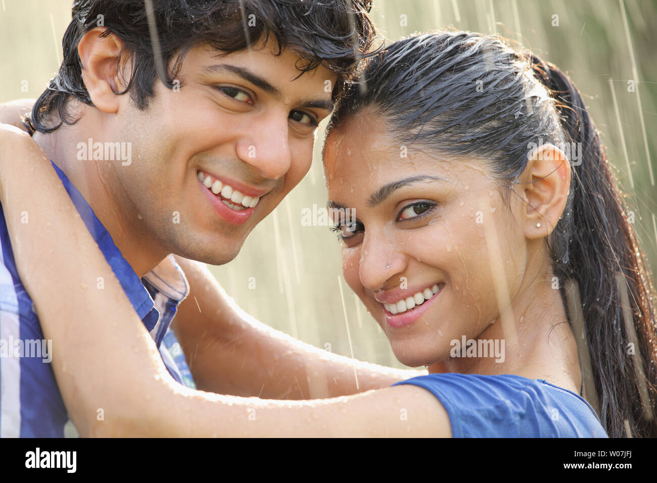 Indian couple romancing in the rain Stock Photo - Alamy