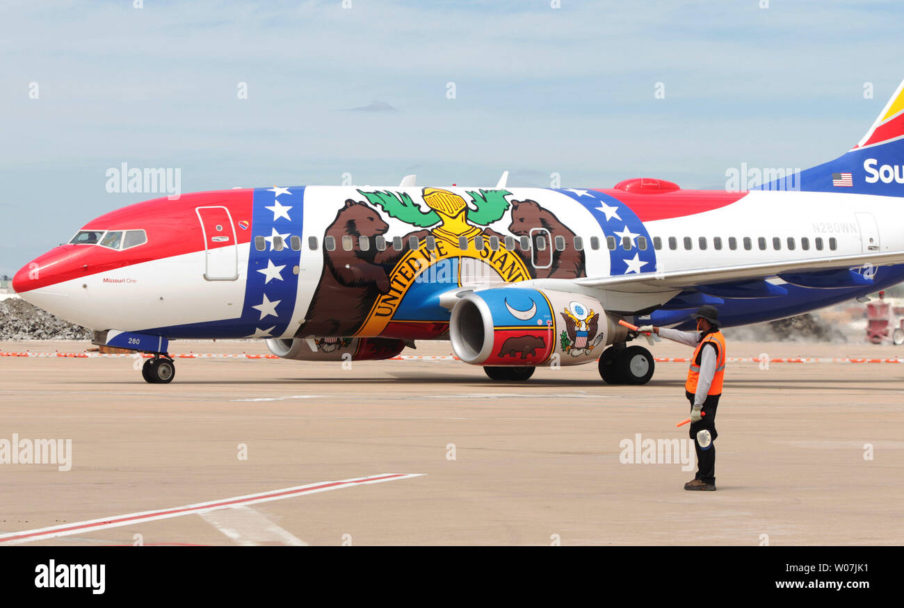 A ramp worker directs the new Southwest Airlines "Missouri One" Boeing ...