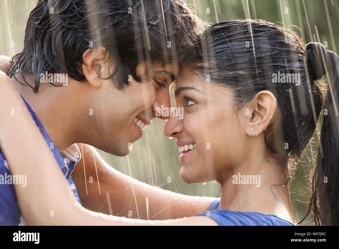 Indian young couple romancing in the rain Stock Photo - Alamy