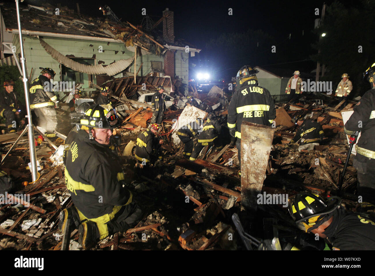 St. Louis firefighters sift through the remains of a home looking for ...