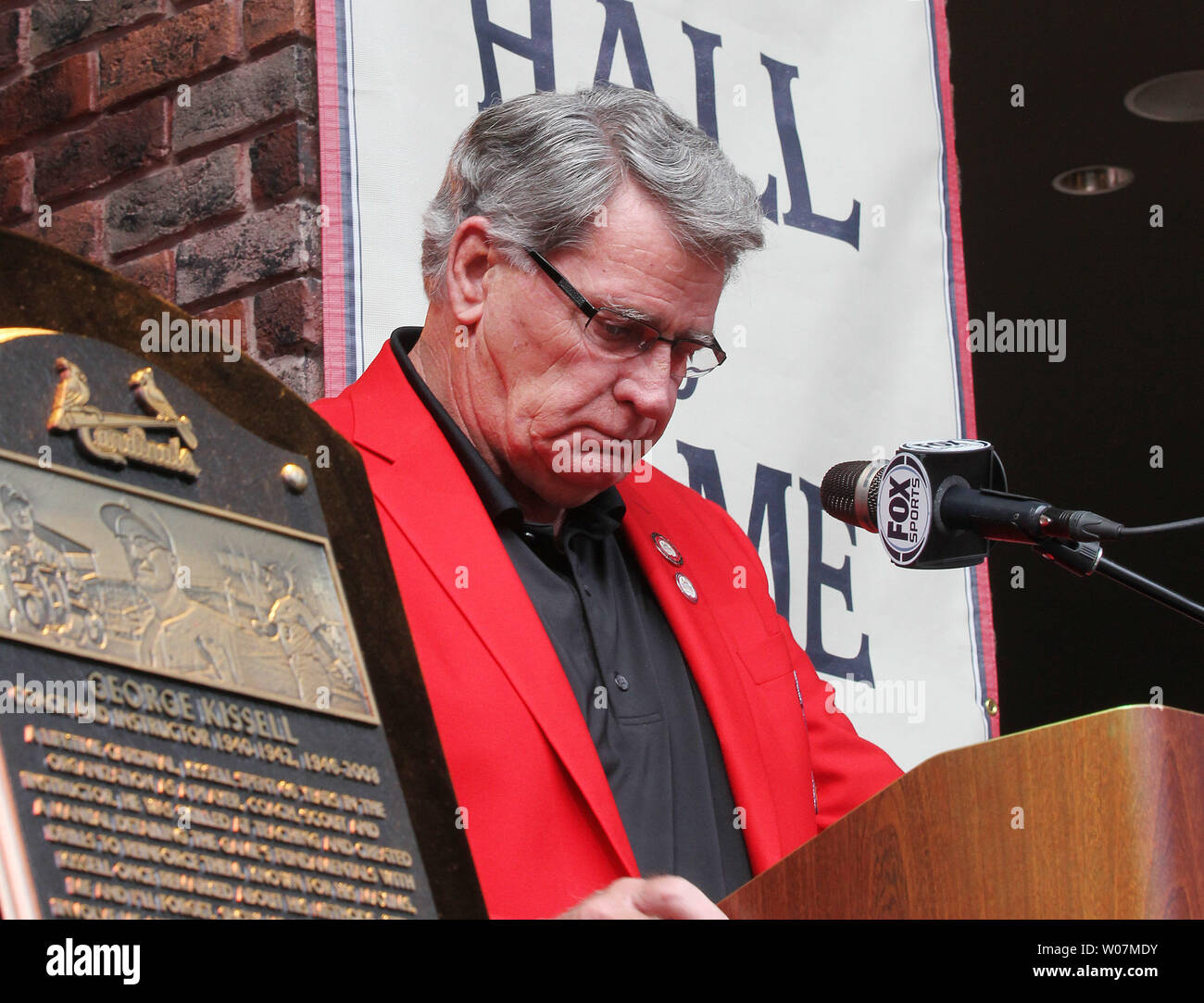 St. Louis Cardinals broadcaster Mike Shannon stops to collect his ...