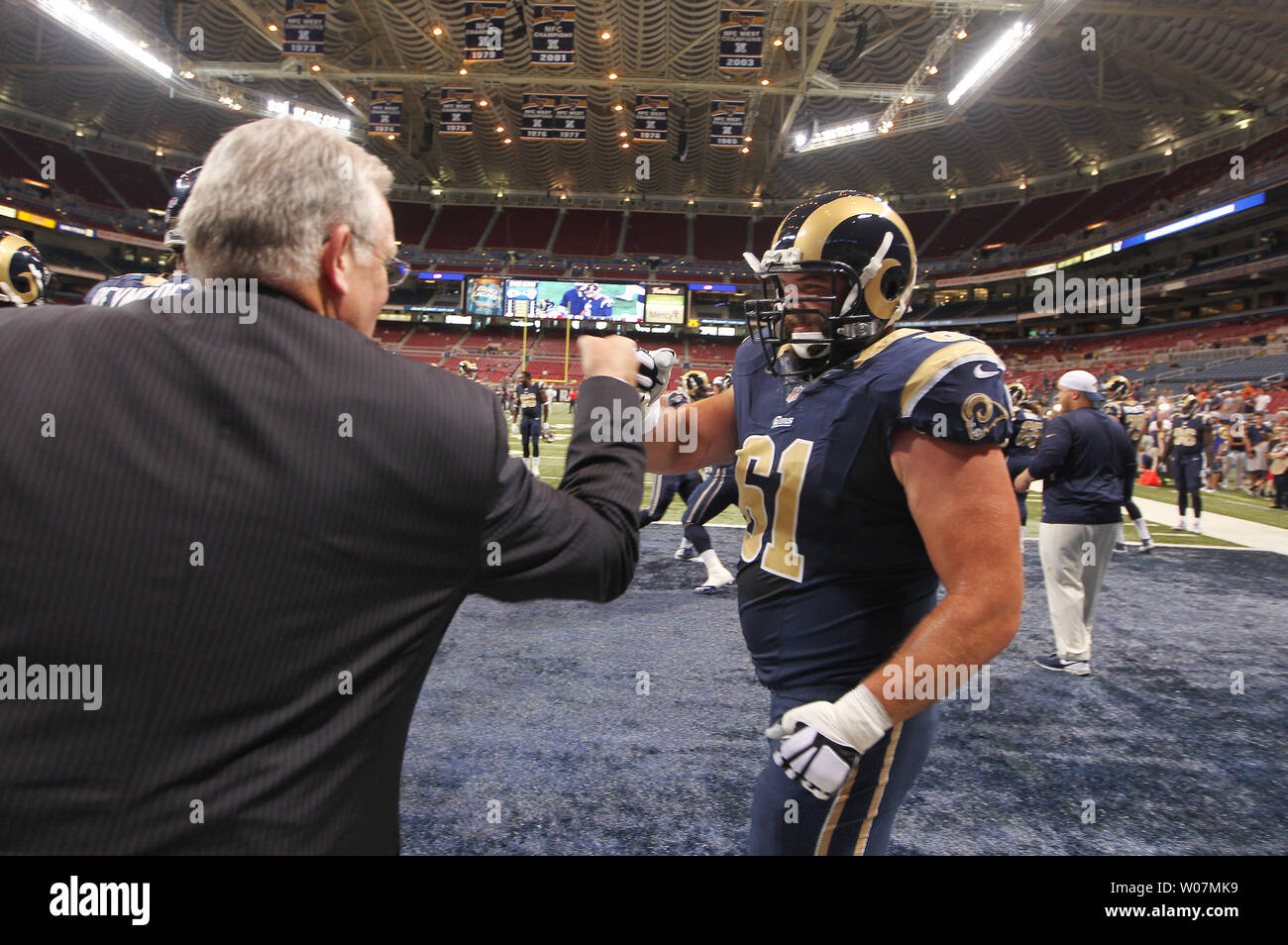 Missouri Governor Jay Nixon bumps fists with St. Louis Rams center Tim ...