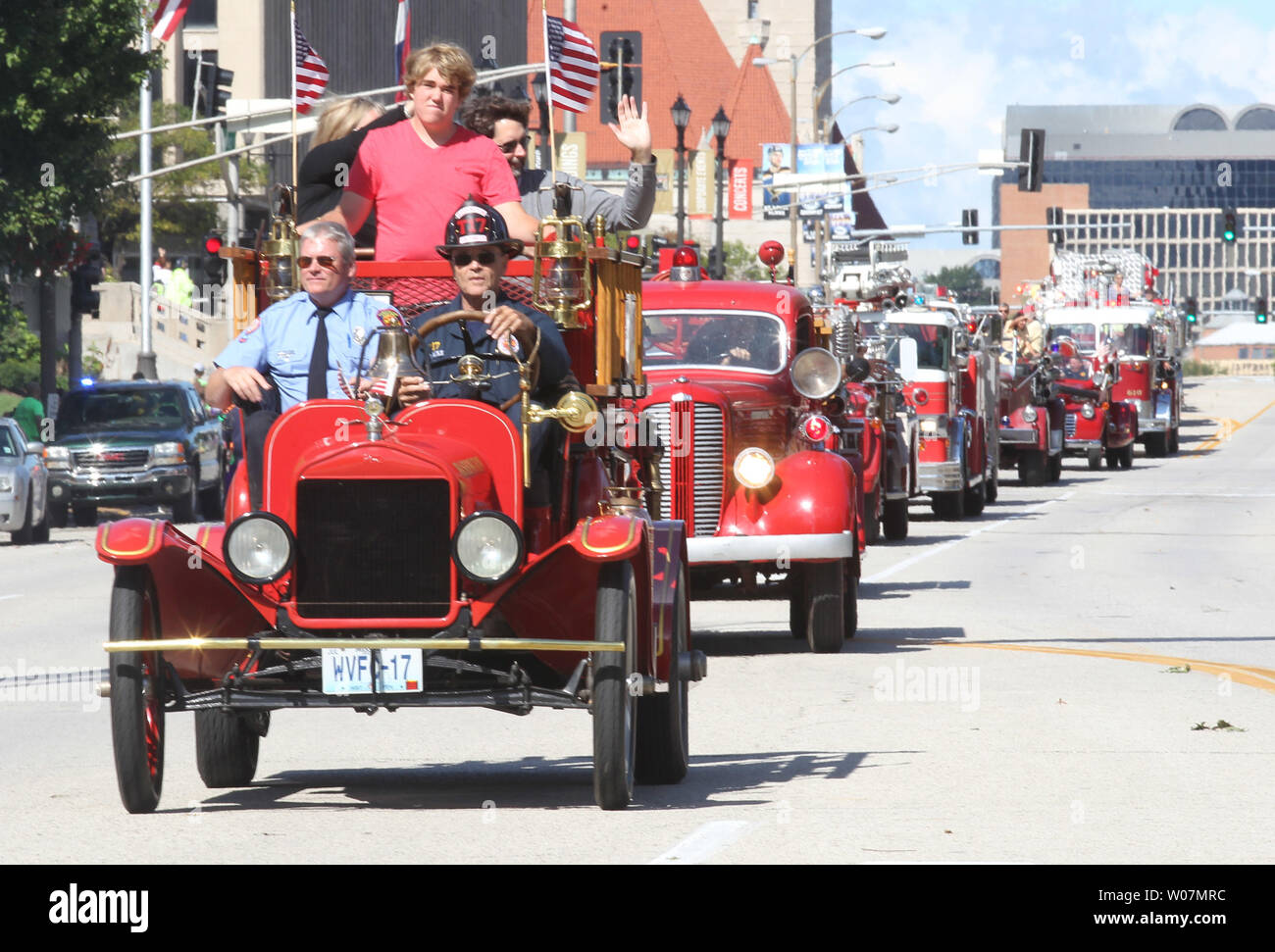 Fire engines of all ages make their way down Market Street during the ...