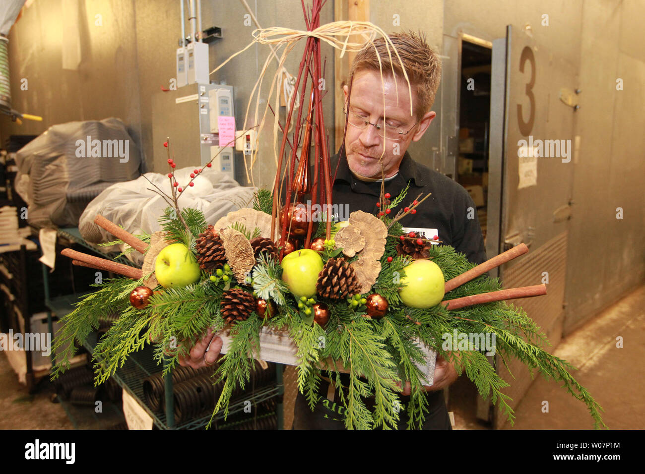 Master floral arranger Scott Hepper puts the finishing touches on a ...
