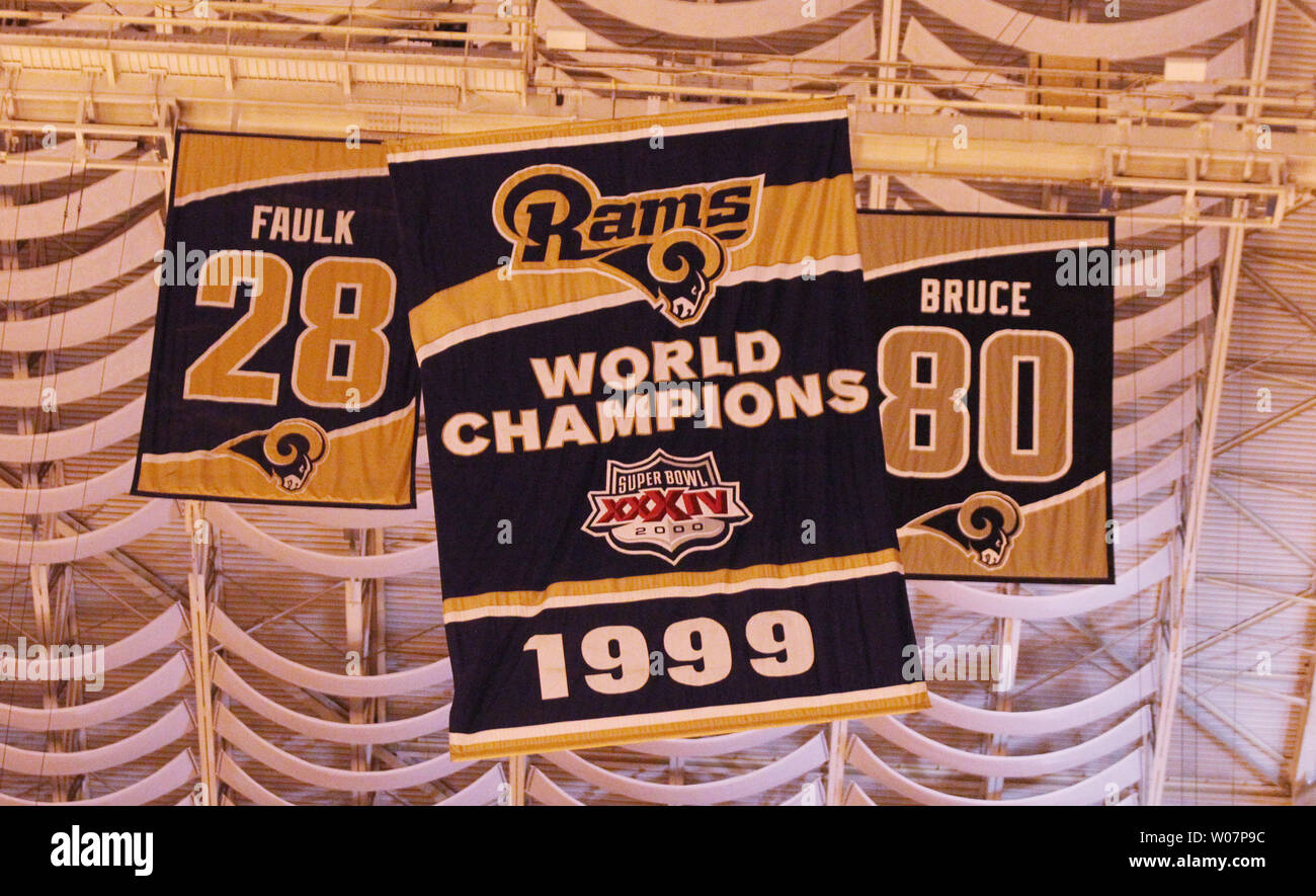 Decoraters lower the St. Louis Rams Super Bowl banner past the Issac ...