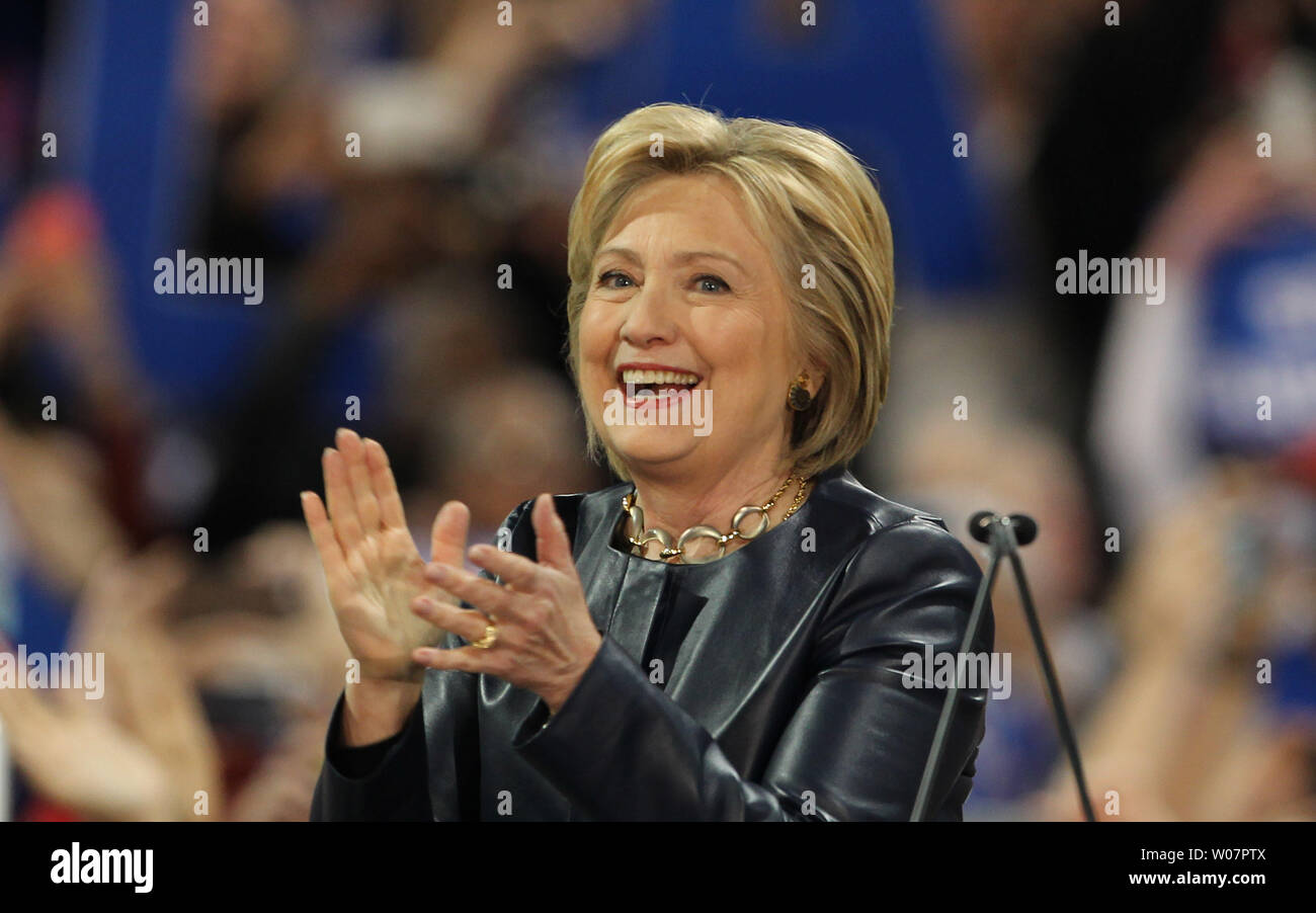 Democratic Presidential candidate Hillary Clinton claps her hands as ...