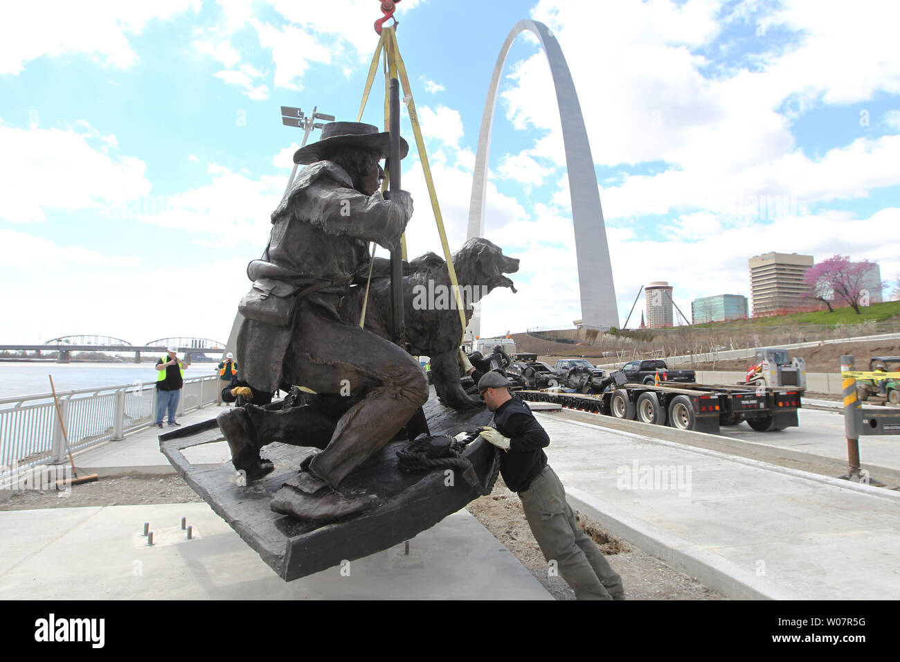 Worker Vlad Zhiromirsky pushes the Lewis and Clark statue into place as ...