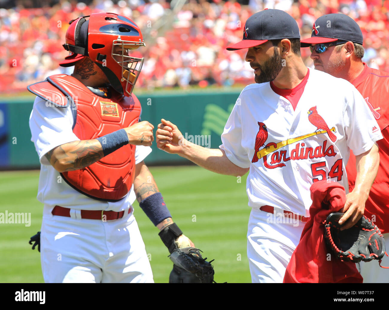 St. Louis Cardinals pitcher Jaime Garcia and catcher Yadier Molina bump ...