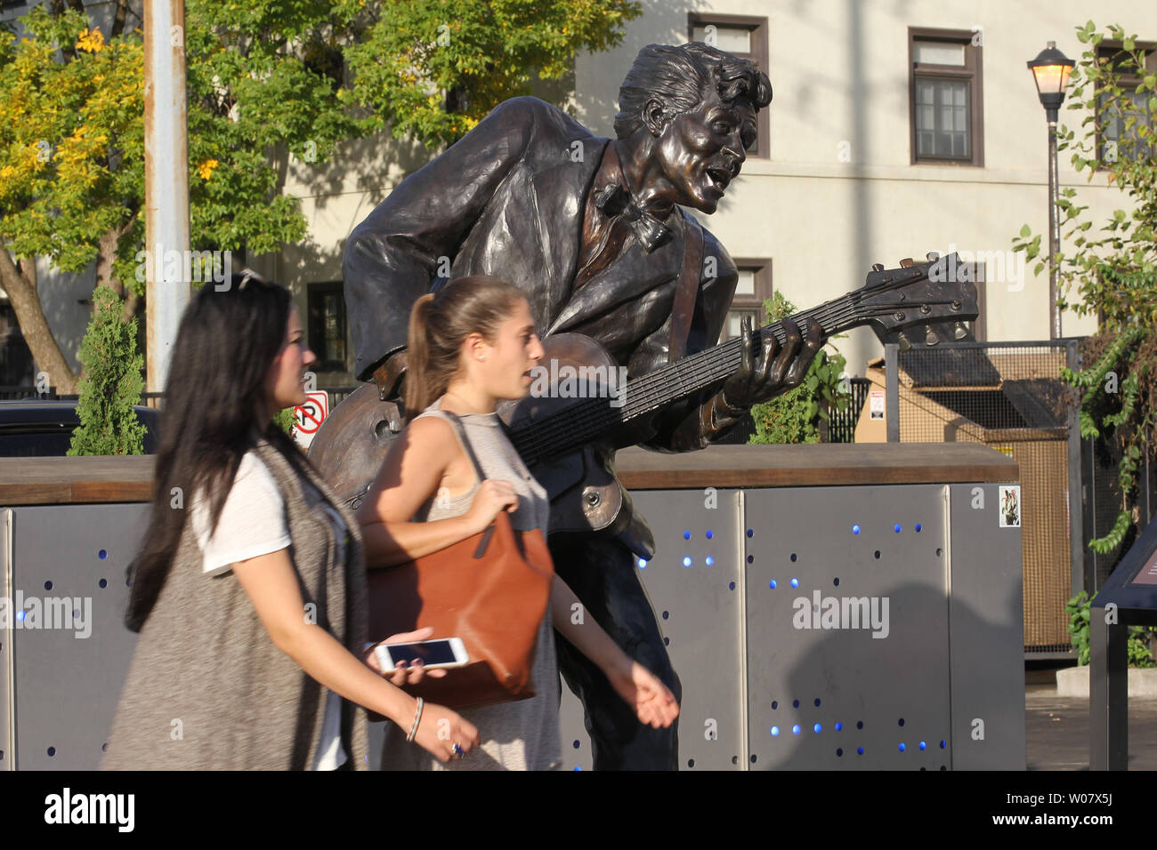 Visitors to the Delmar Loop, walk past the statue of guitarist Chuck ...
