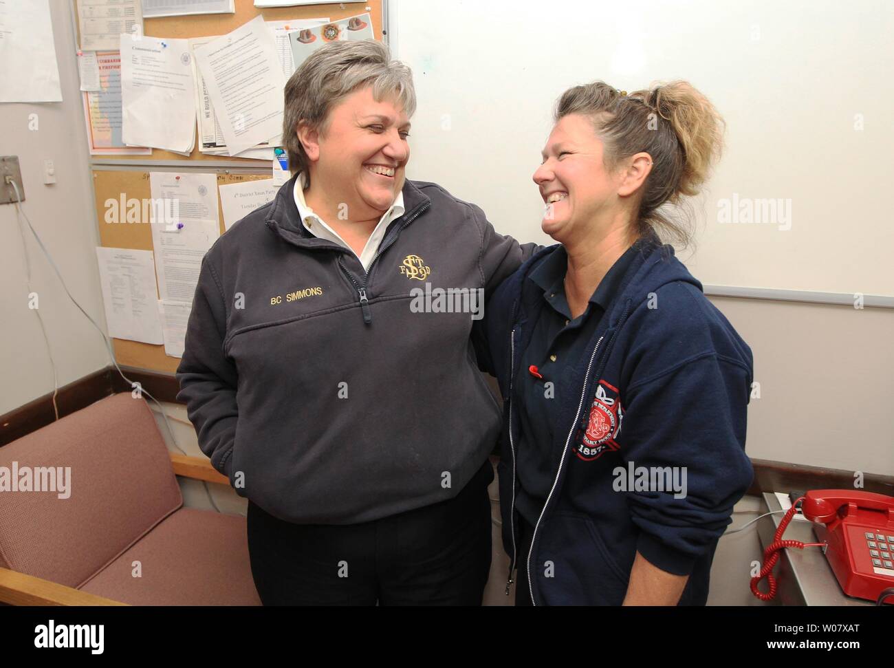 St. Louis Fire Department Captain Lori Riley (R) says goodby to ...