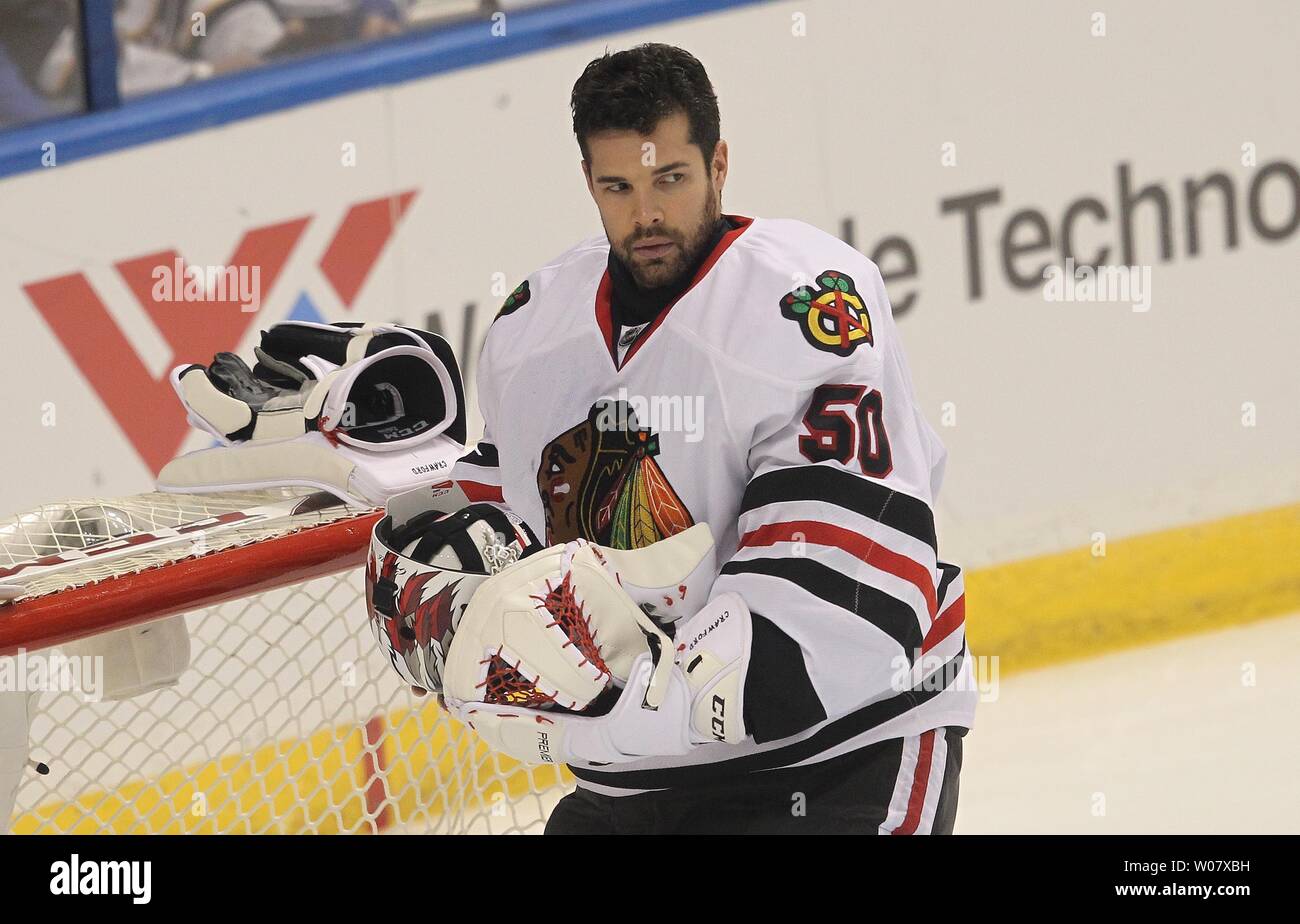 Chicago Blackhawks goaltender Corey Crawford adjusts his mask during a ...