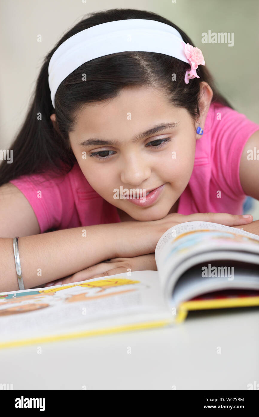 Indian girl reading a book Stock Photo - Alamy