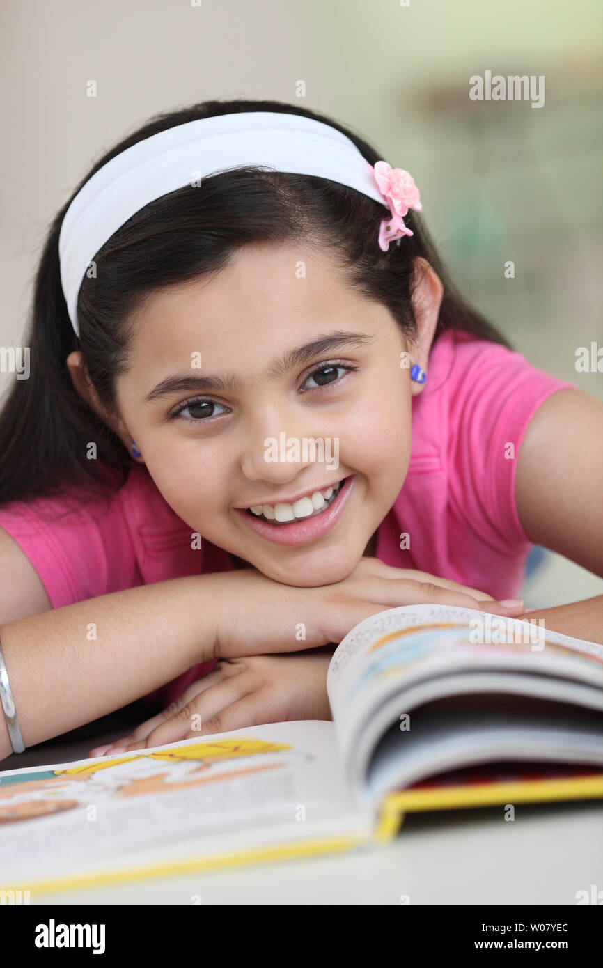 Portrait of an Indian girl reading a book Stock Photo - Alamy