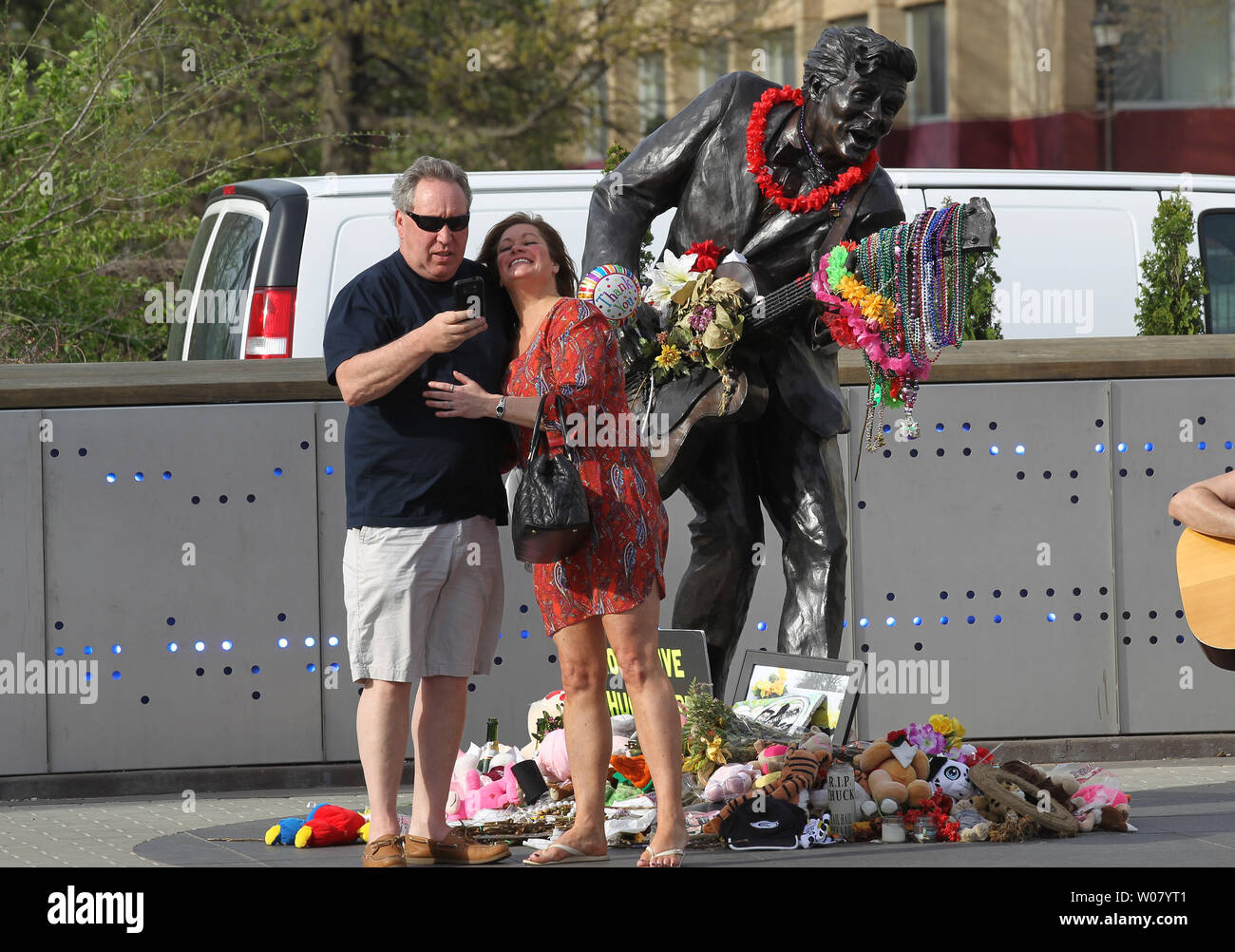 A couple take a selfie in front of the Chuck Berry statue as a funeral ...