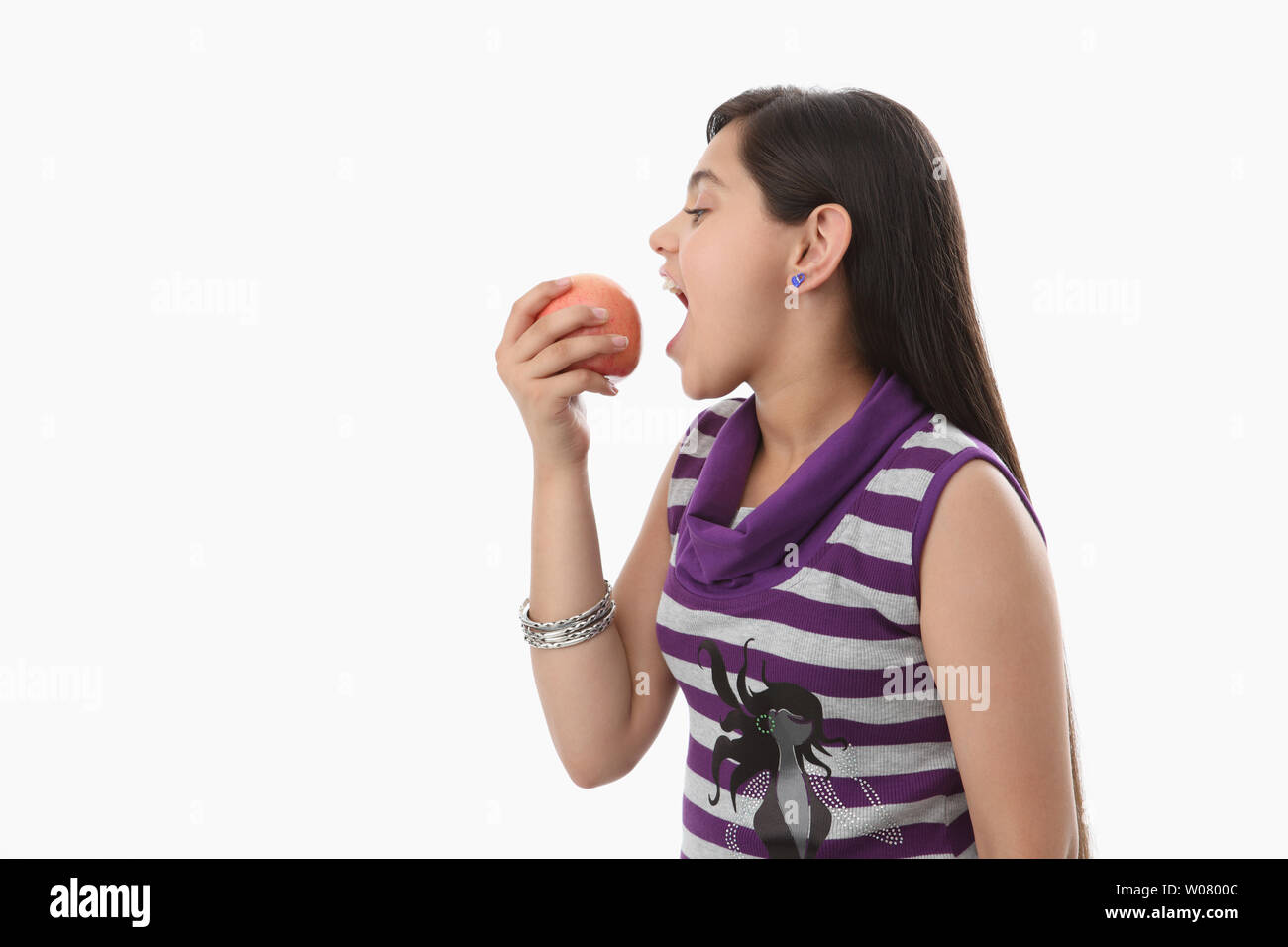 Close up of a girl eating an apple Stock Photo - Alamy