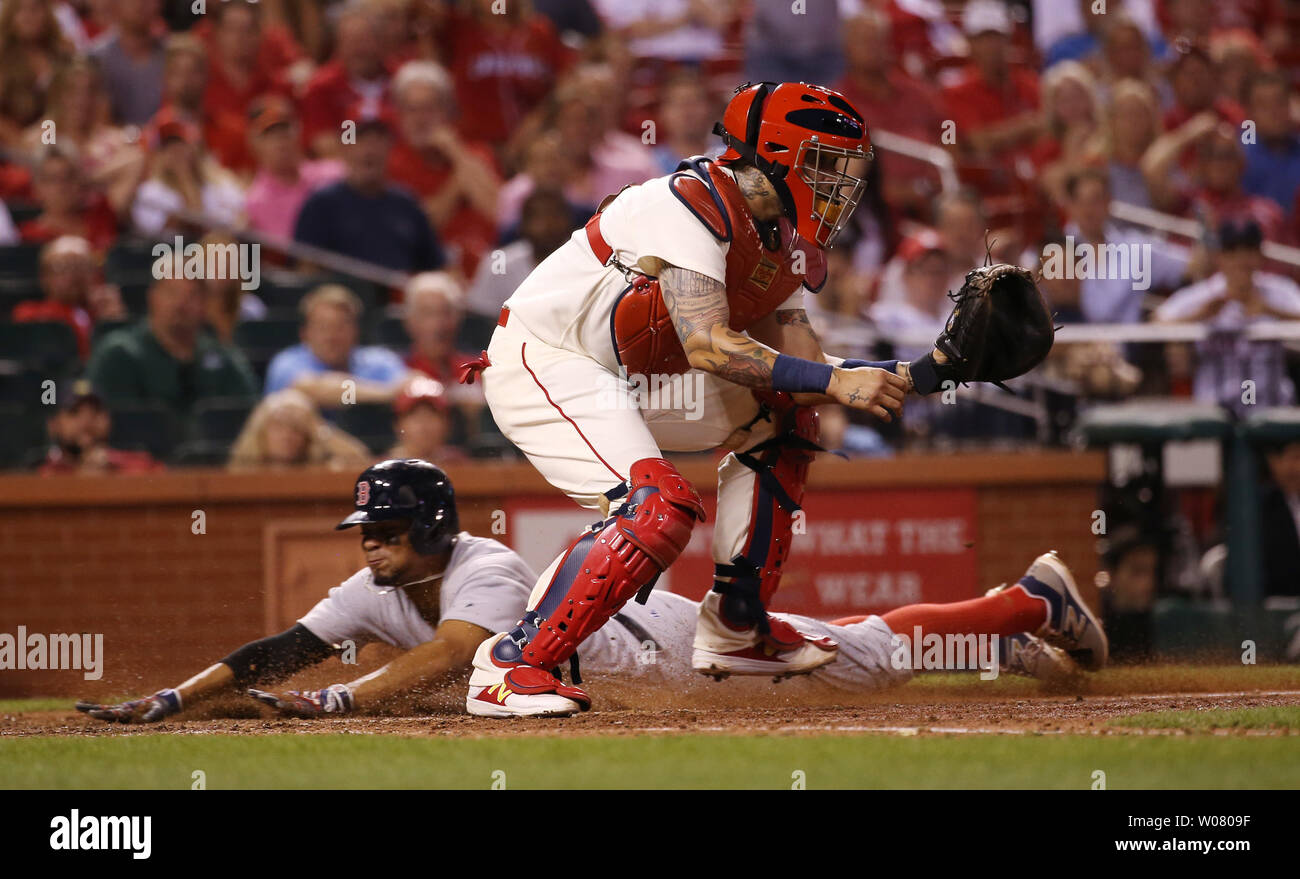 Boston Red Sox Xander Bogaerts slides safely into home plate before the ...
