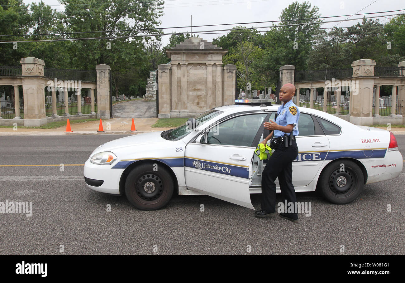 A University City, Missouri police officer stands in front of Chesed ...