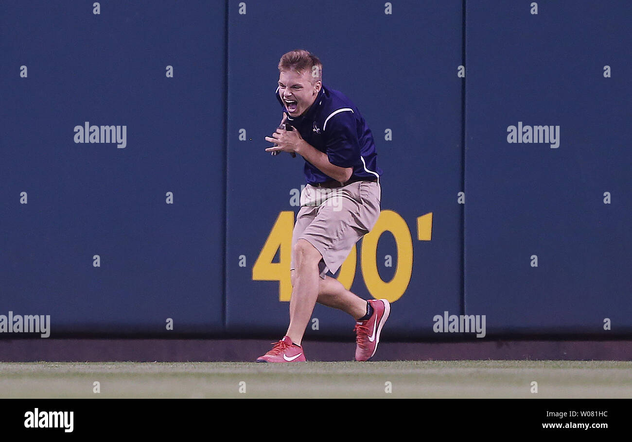 Busch Stadium grounds keeper Lucas Hackmann is scratched by a cat he ...