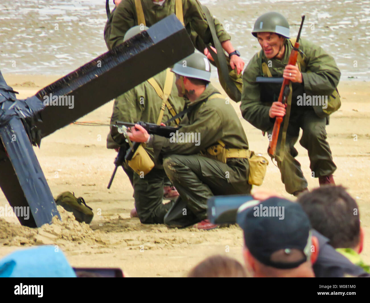 UTAH, FRANCE - June 06, 2019. Special forces men in camouflage uniforms on beach. Diversionary ...