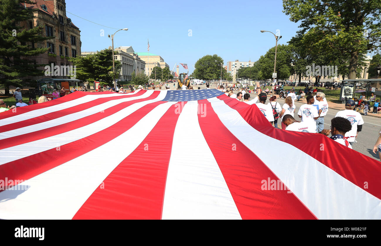 Painter's union members carry a large, oversized Ameican flag during ...
