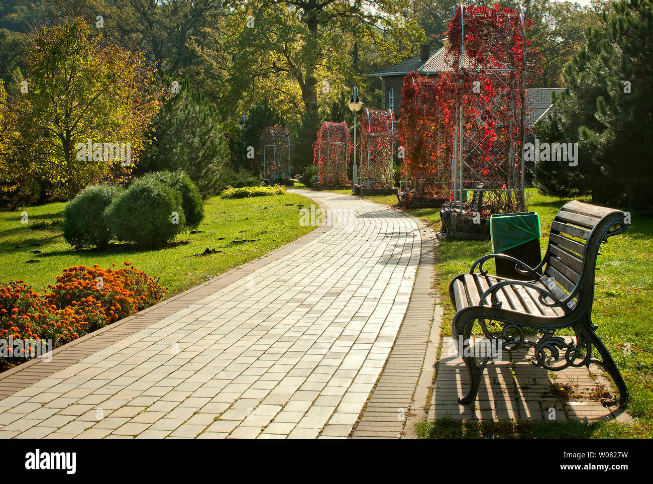 Beautiful park with pathway, arbors and benches Stock Photo - Alamy