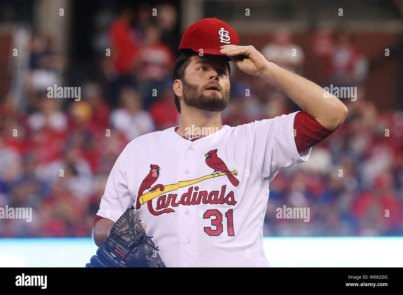 St. Louis Cardinals starting pitcher Lance Lynn adjusts his cap after ...