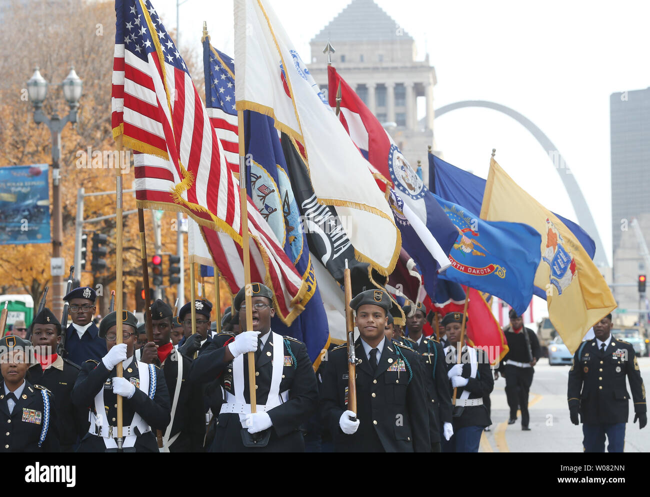 Members of a local ROTC school march and carry flags during the St ...