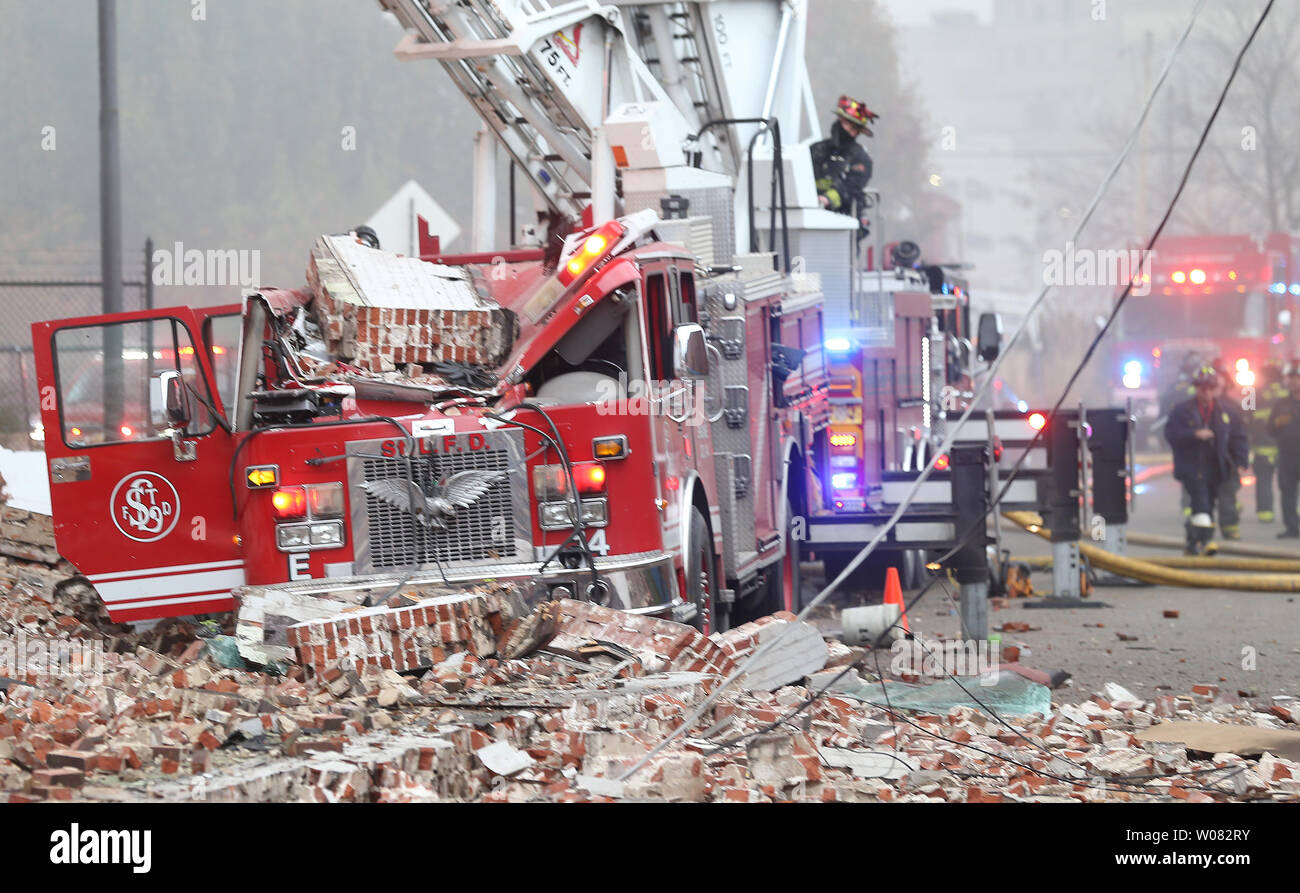 A fire rages out of control in a warehouse after a wall collapsed on a ...