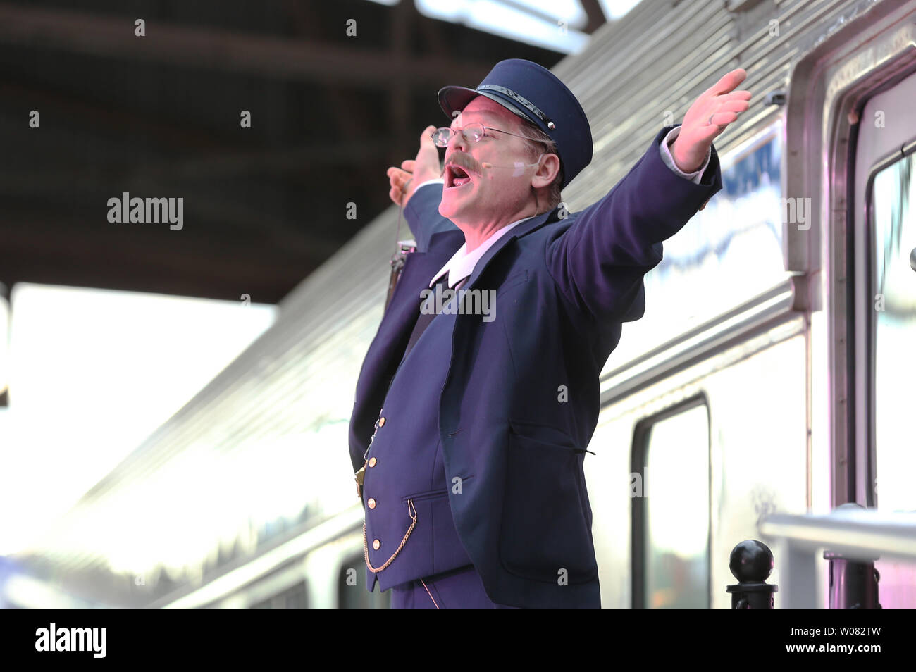 A conductor announces that riders can board the train cars for the ...