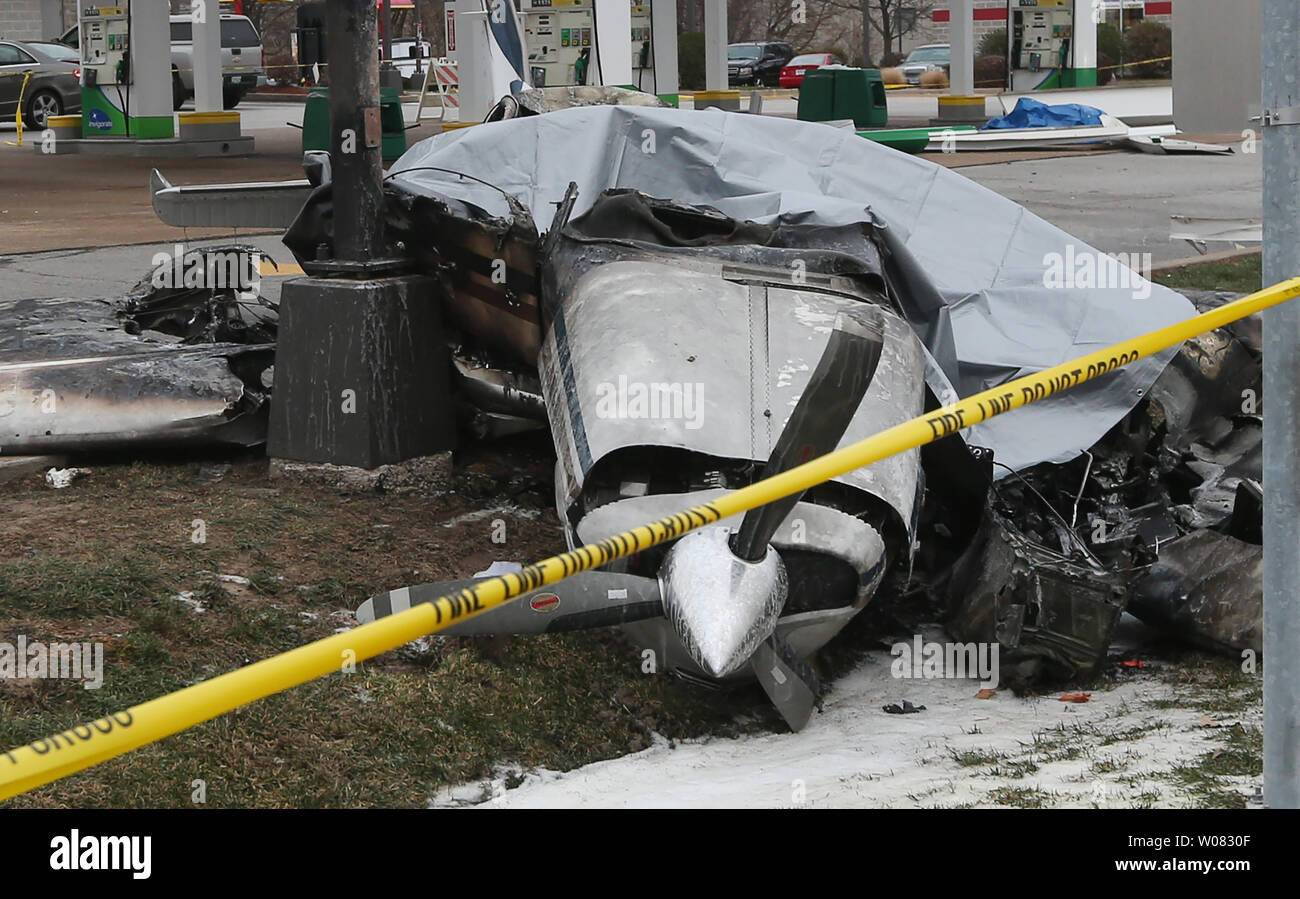 Police tape surrounds the remains of a Beechcraft plane that crashed ...