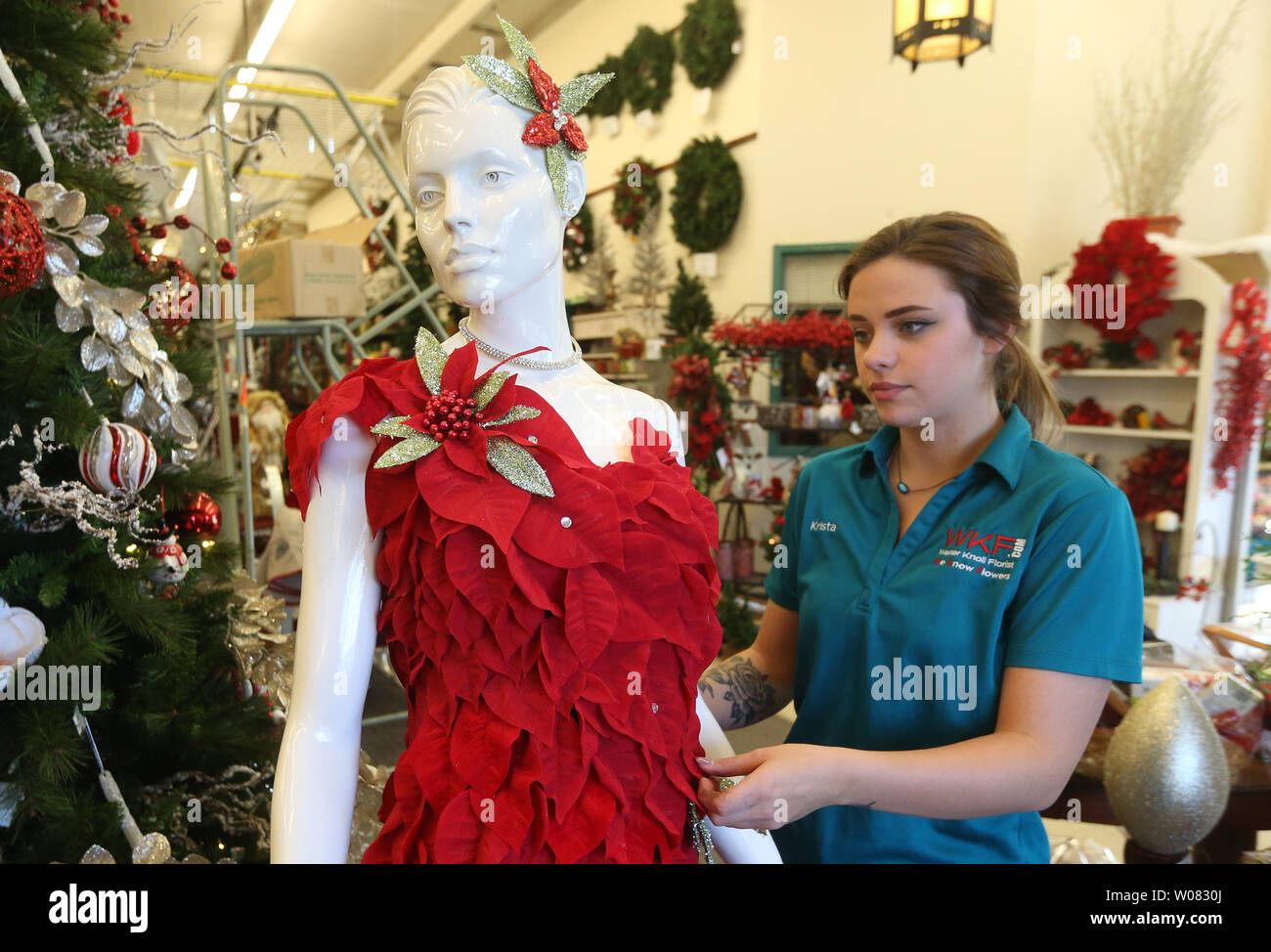 Flower designer Krista Russell puts some finishing touches on a ...