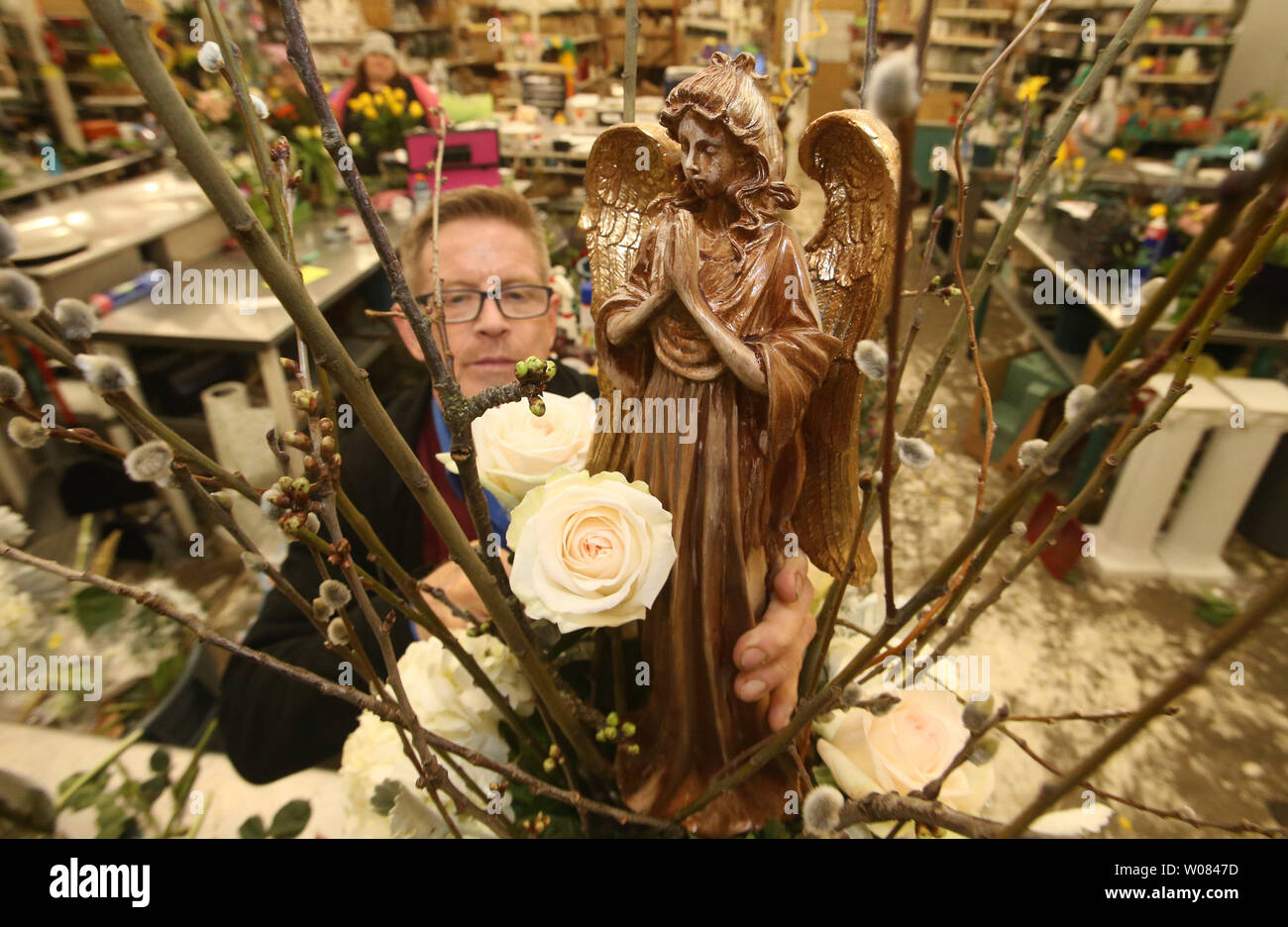 Master floral arranger Scott Hepper adds a angel onto a Easter flower ...