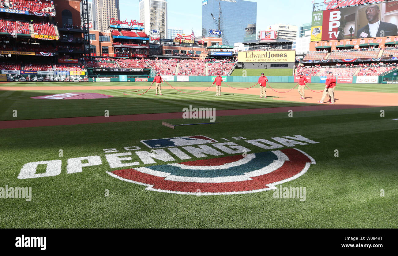 Busch Stadium grounds crew members hose down the infield as work ...