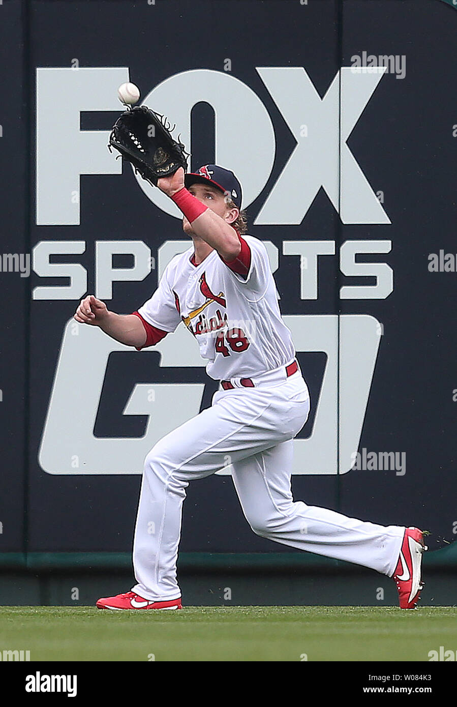 St. Louis Cardinals center fielder Harrison Bader gets under a ball off ...